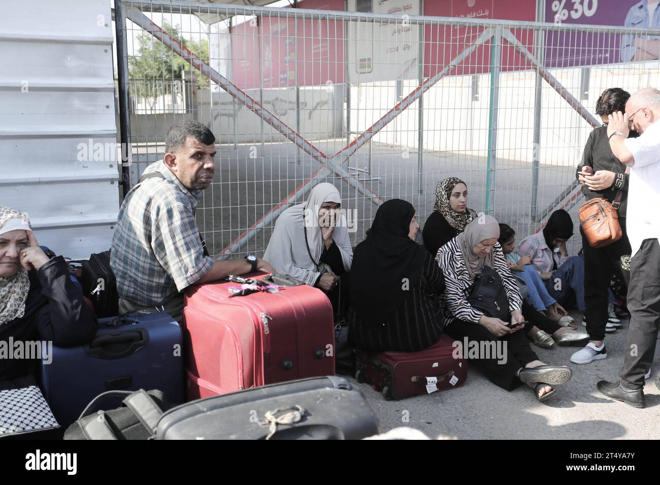 People walk through a gate to enter the Rafah border crossing to Egypt ...