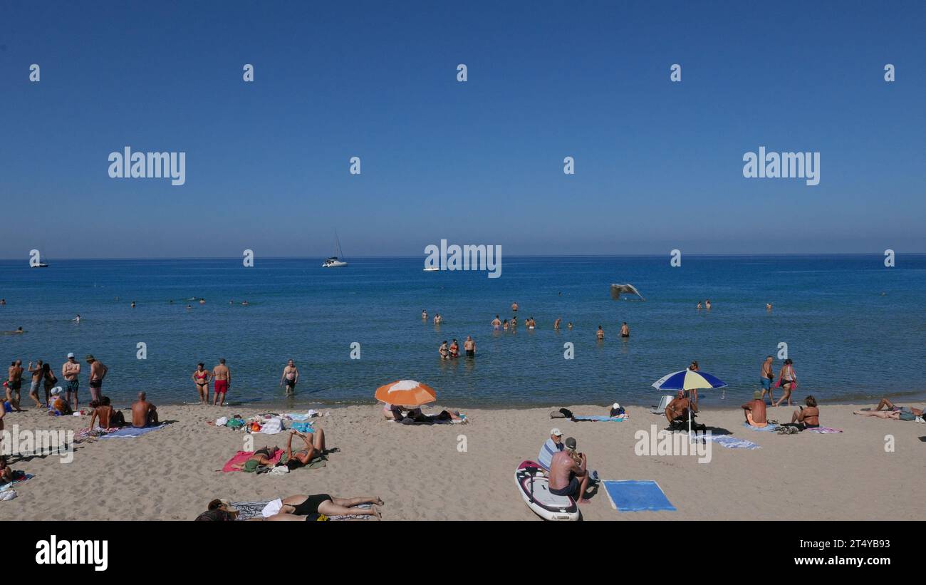 Sunbathers on beach at Cefalu on the Italian Island of Sicily. Summer ...