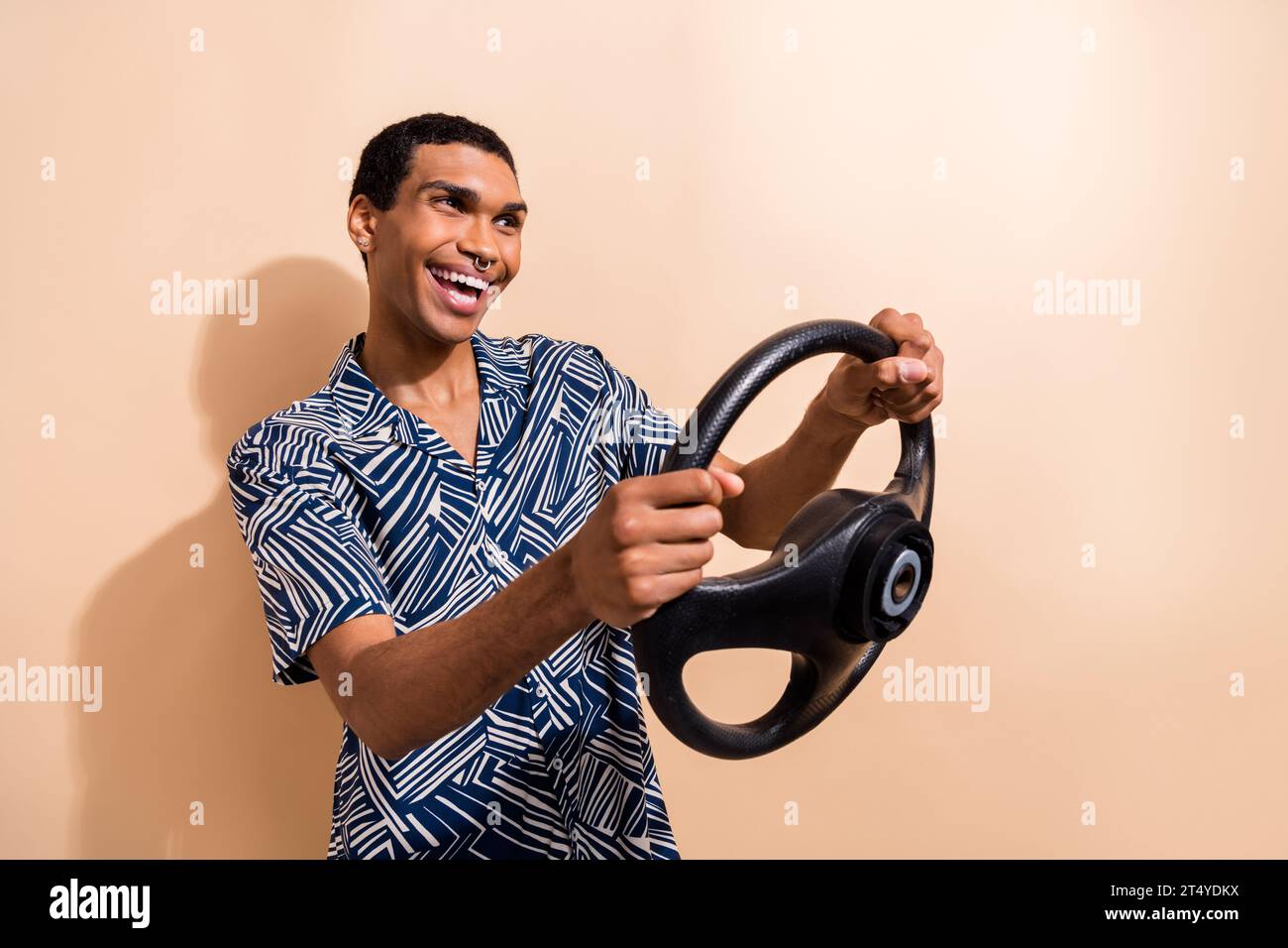 Photo portrait of nice young male hold steering wheel drive wear trendy ...