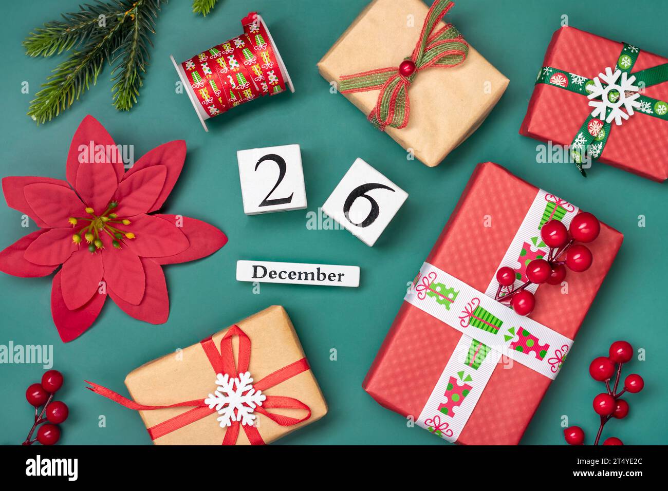 Gift boxes, wooden calendar with date December 26 on green background ...