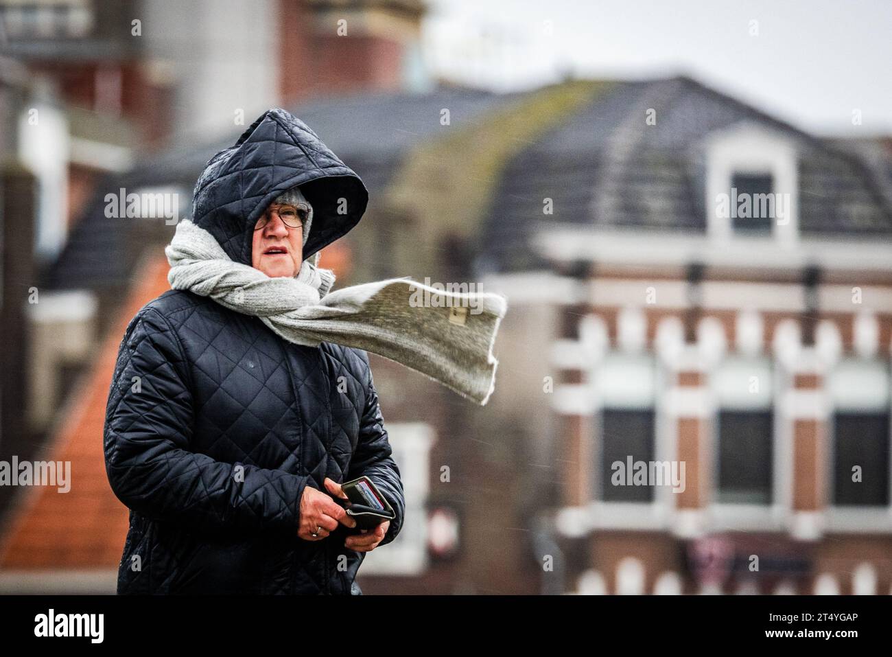 VLISSINGEN - People walk along the coast in Vlissingen during storm ...