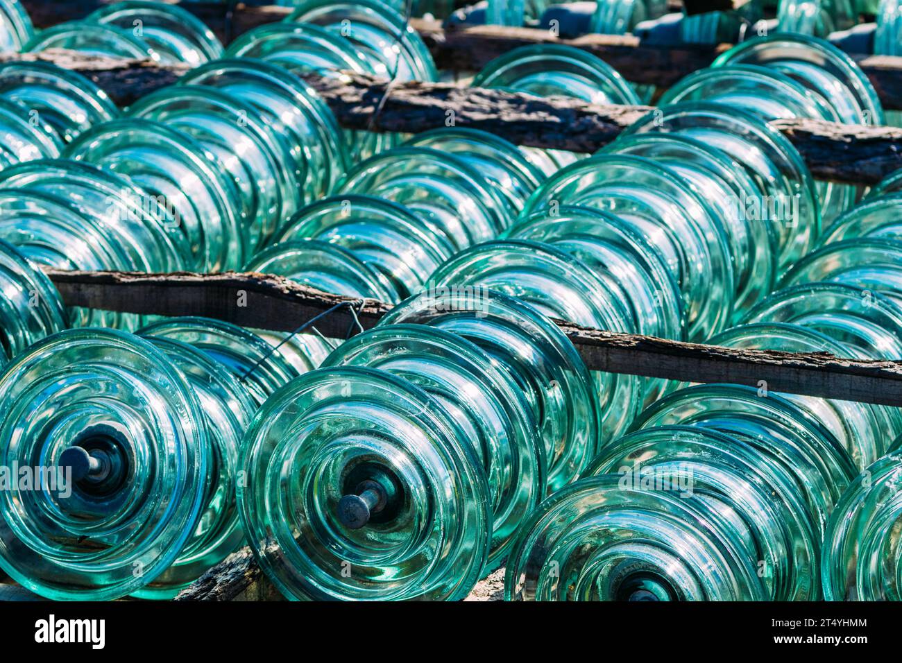 Glass transparent high-voltage insulator is in storage. Industrial ...