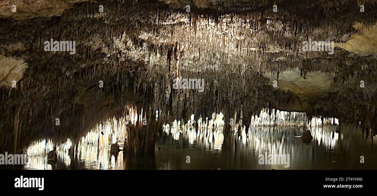 An image of an underground cave filled with crystal clear water and ...