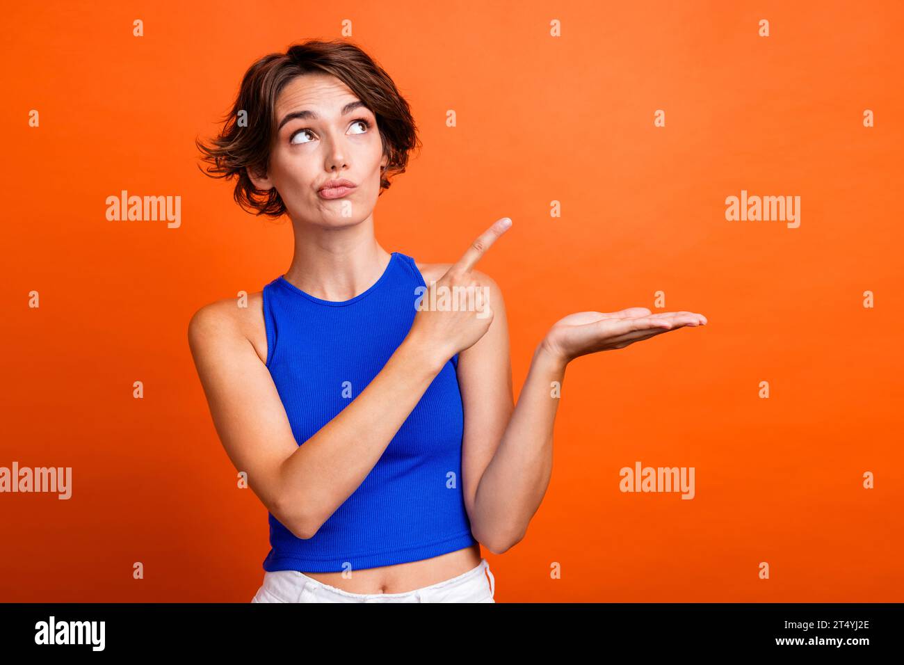 Photo of doubtful unsure lady wear blue singlet looking showing finger ...