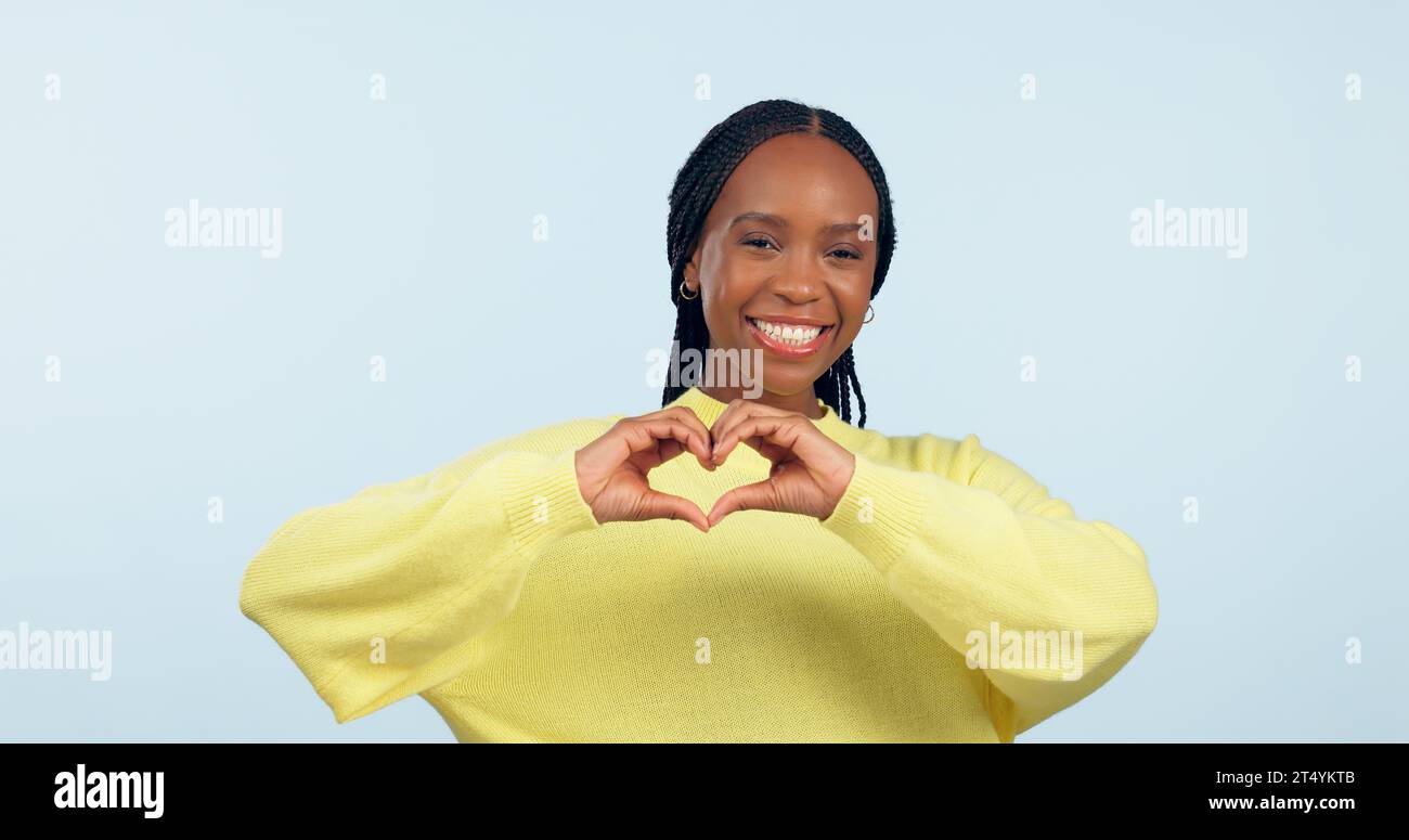 Portrait, heart and hands of black woman in studio for love, kindness ...