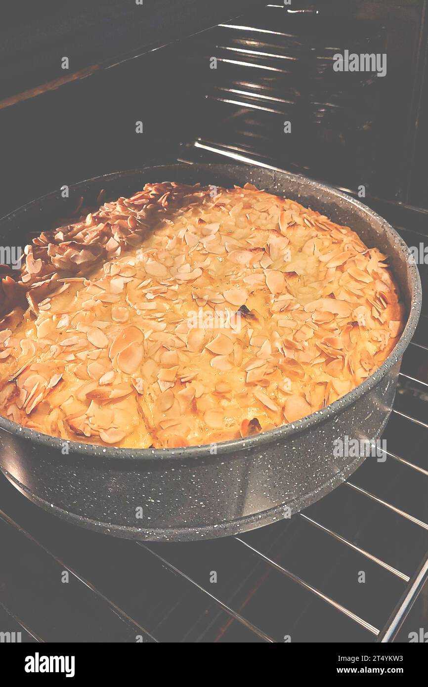 Homemade cakes. Golden apple pie with almonds in the oven Stock Photo ...