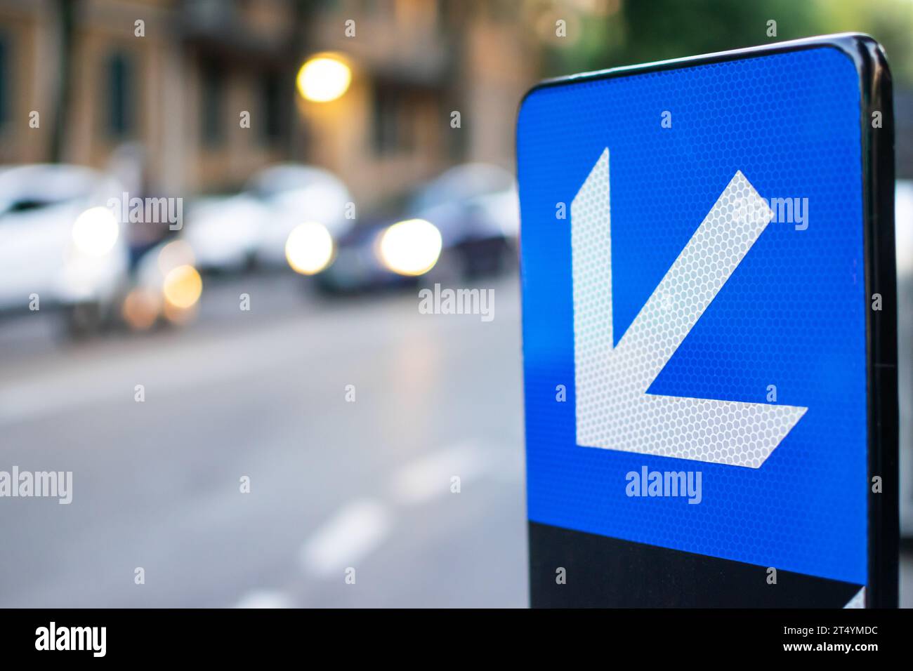 Traffic signal showing direction with some vehicles defocused in ...