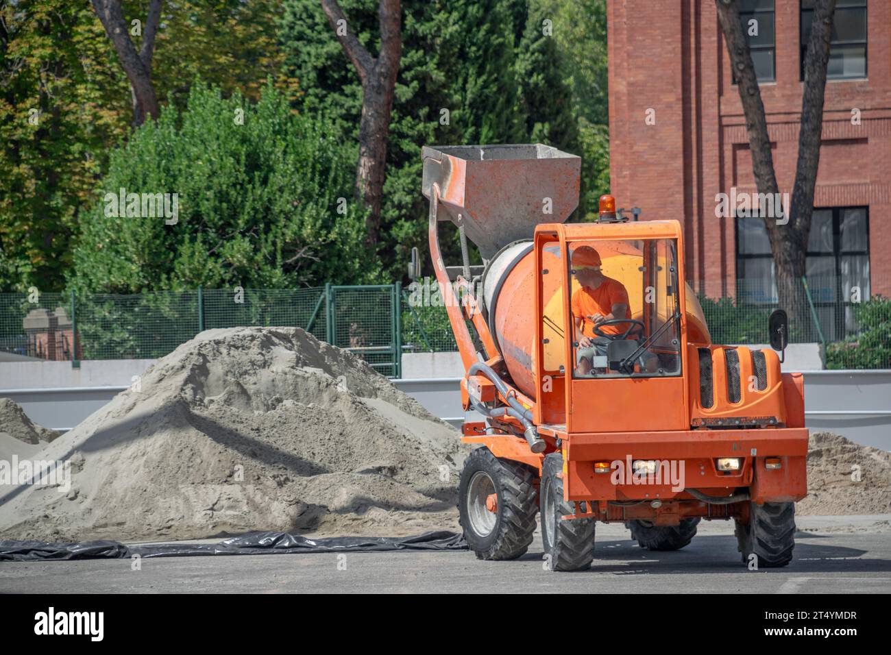 Small Cement truck transporting and turning dry cement by skilled ...