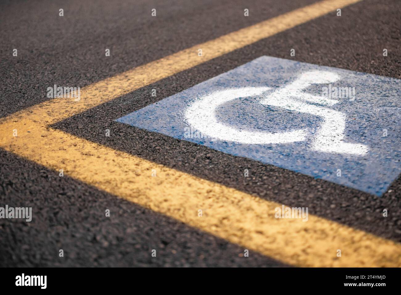 Parking sign for disabled on asphalt with yellow lines Stock Photo - Alamy