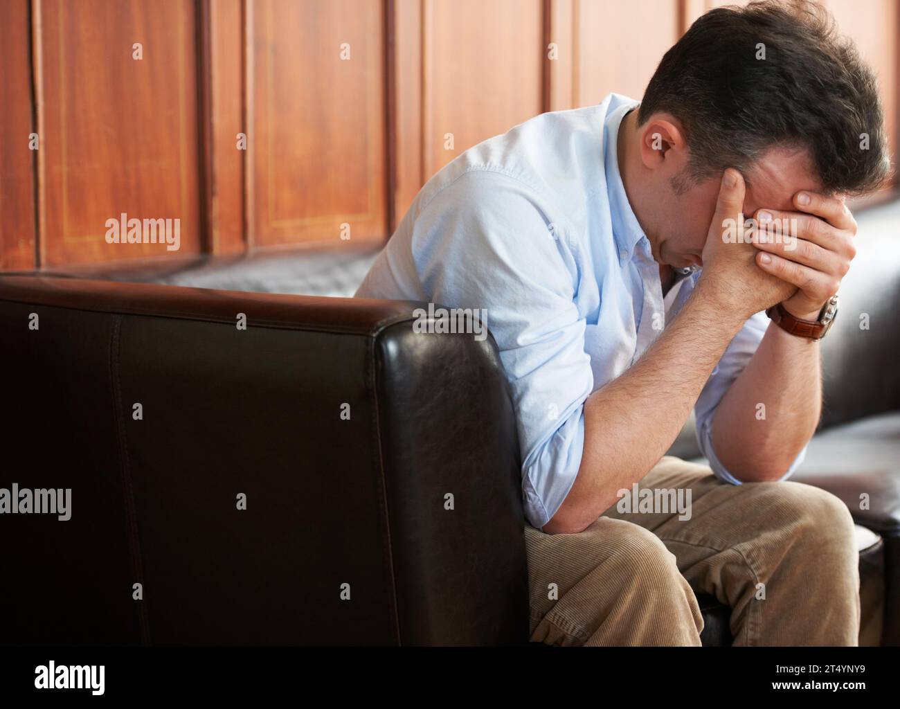 Sad, man and stress on sofa in waiting room with loss of job from ...