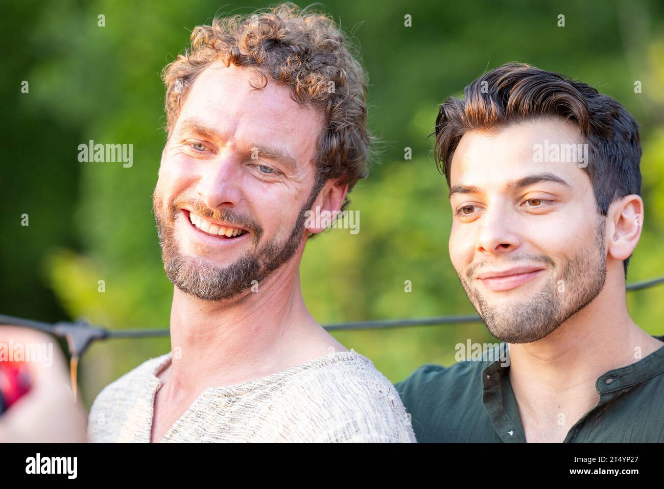 Two attractive young millennial men, one Caucasian and one with a ...