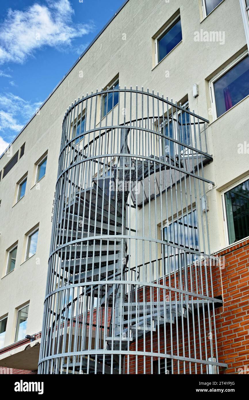 A spiral staircase running down the side of a building. Emergency exit ...