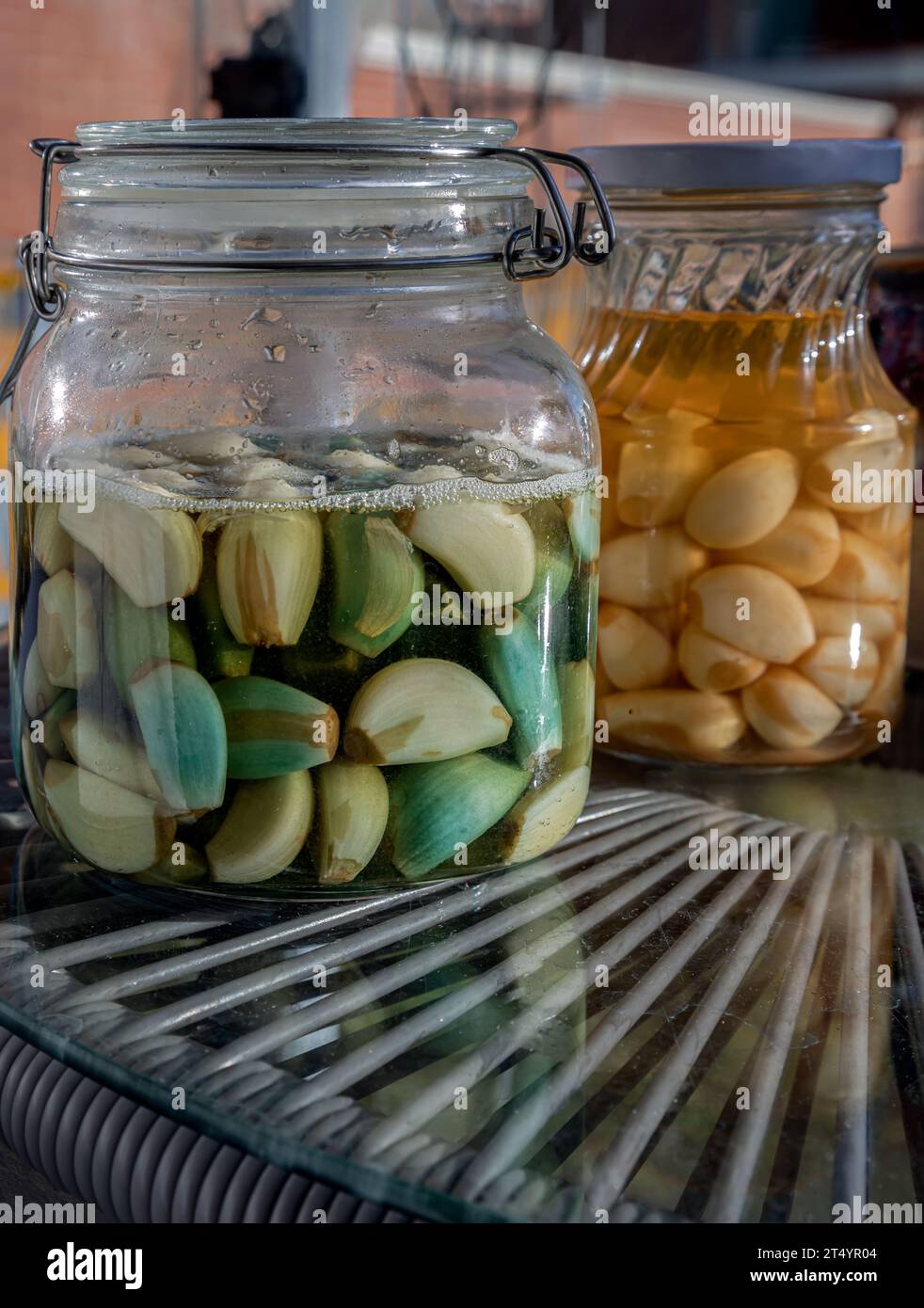 Glass jars with Garlic pickled in Apple cider vinegar with Rock sugar ...