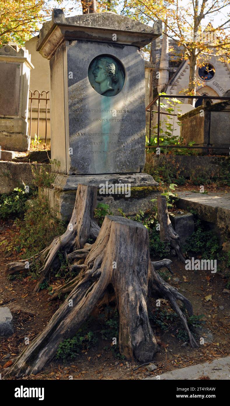 Weathered tree stumps stand in front of a grave in Paris' historic Père ...