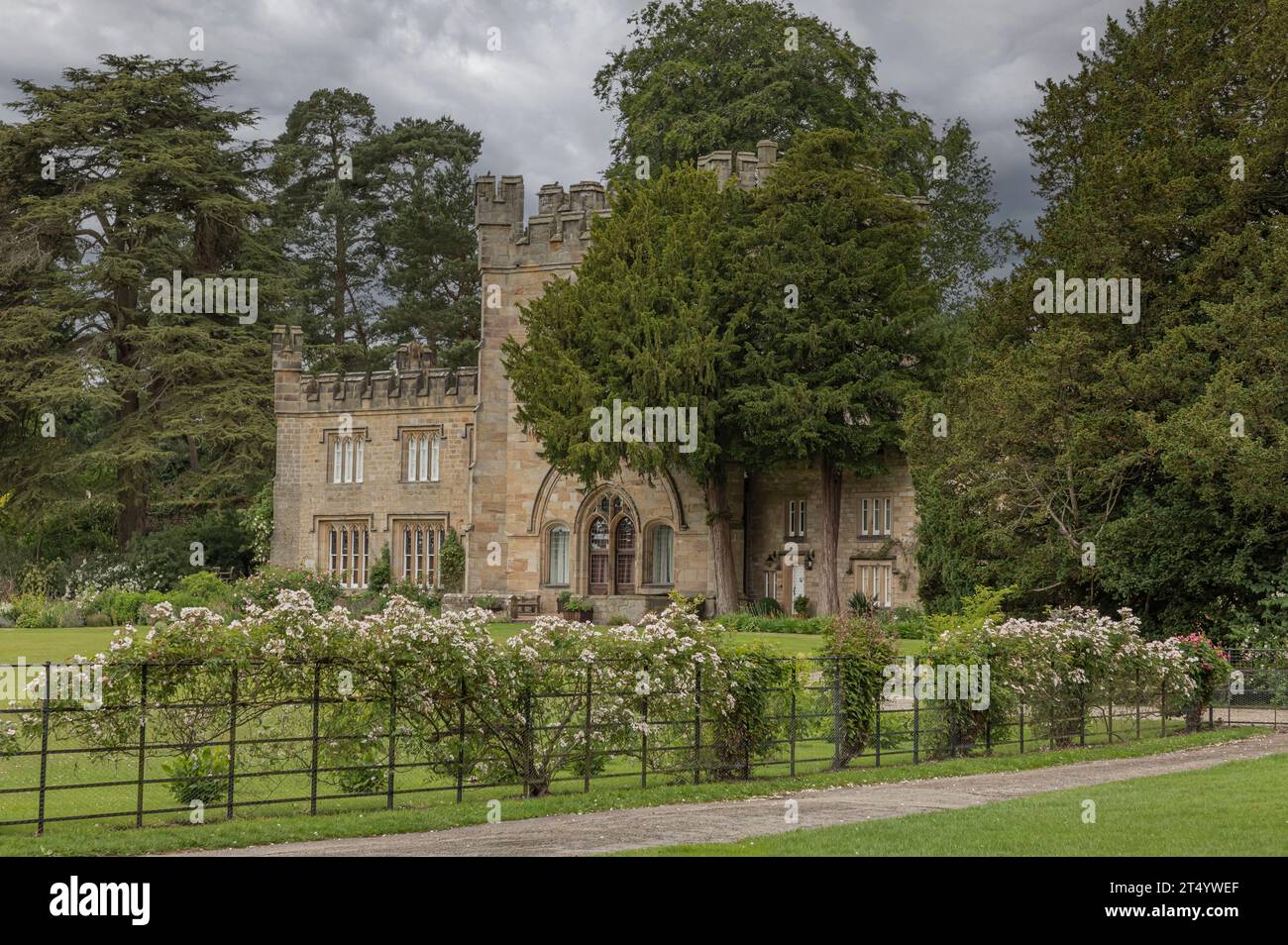 Castle in some trees behind a wrought iron fence Stock Photo - Alamy