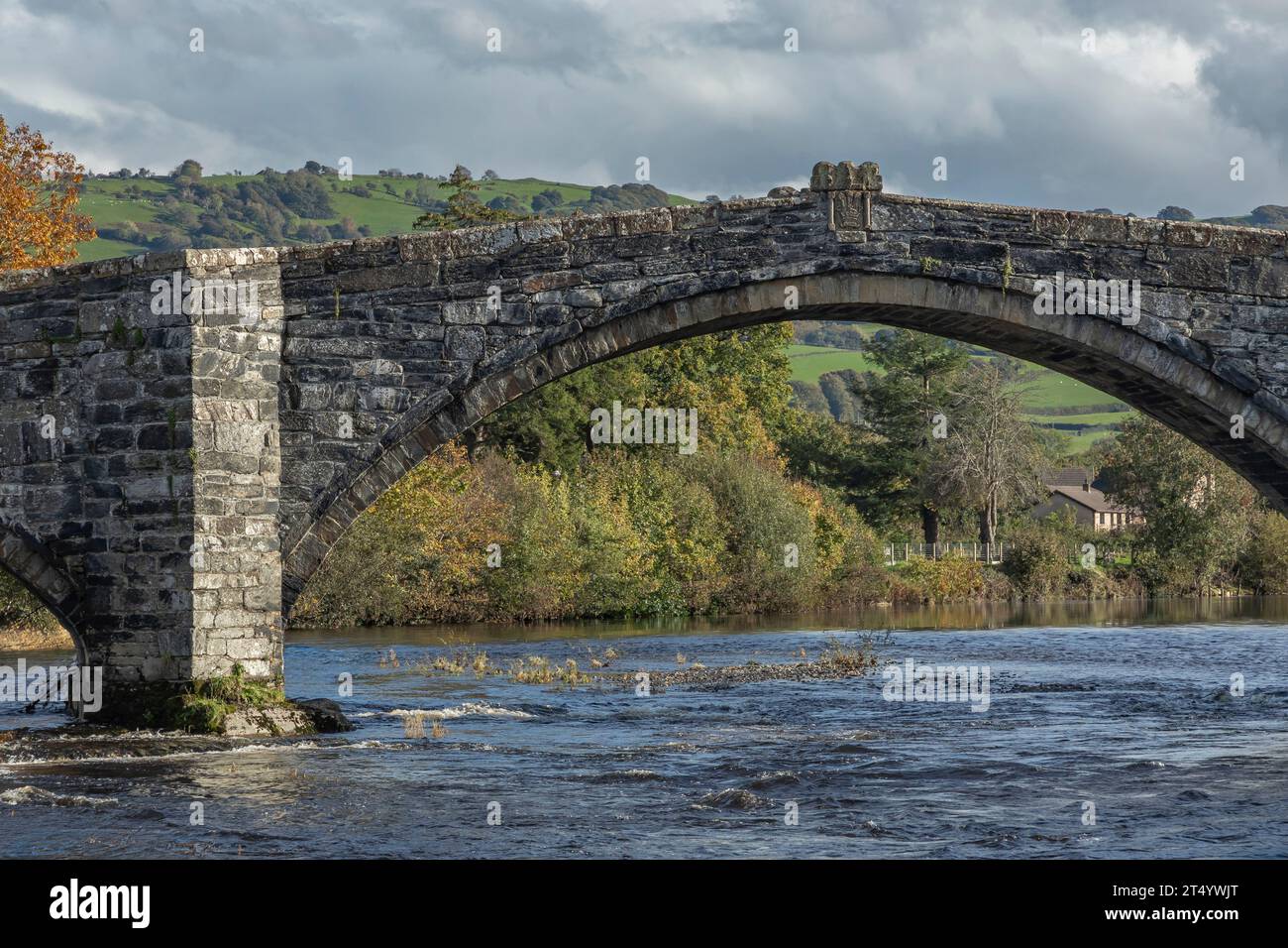 Looking through an acient bridge at across the river bank at the ...