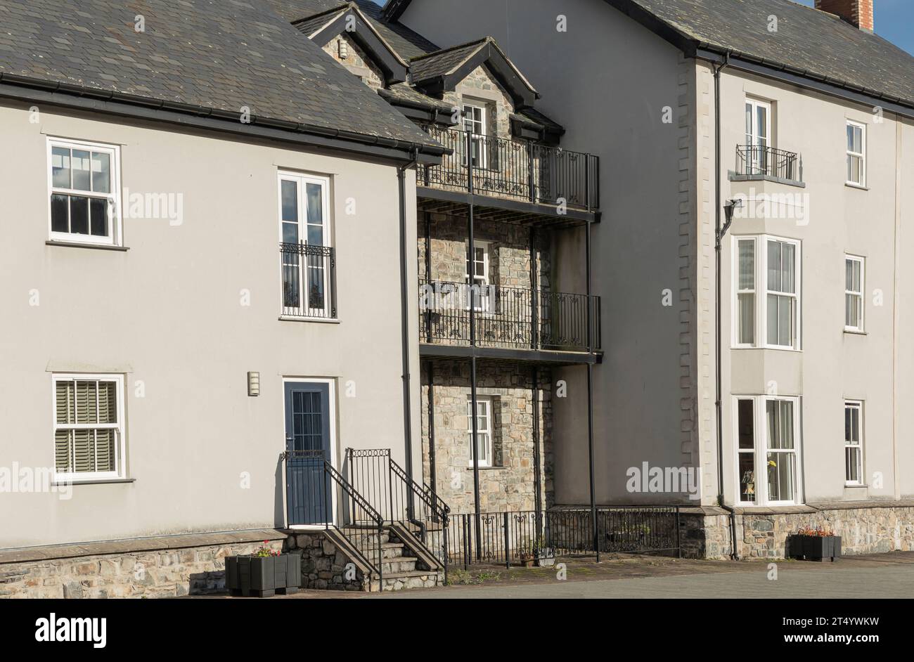 Small slate coloured stone building squeezed between two other ...