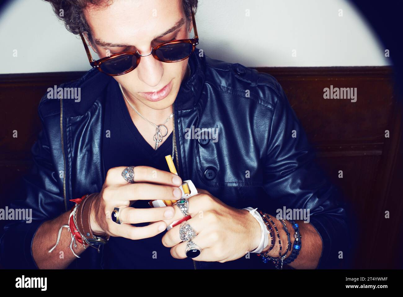 Man with cigarette in hand, grunge fashion and rockstar attitude on ...