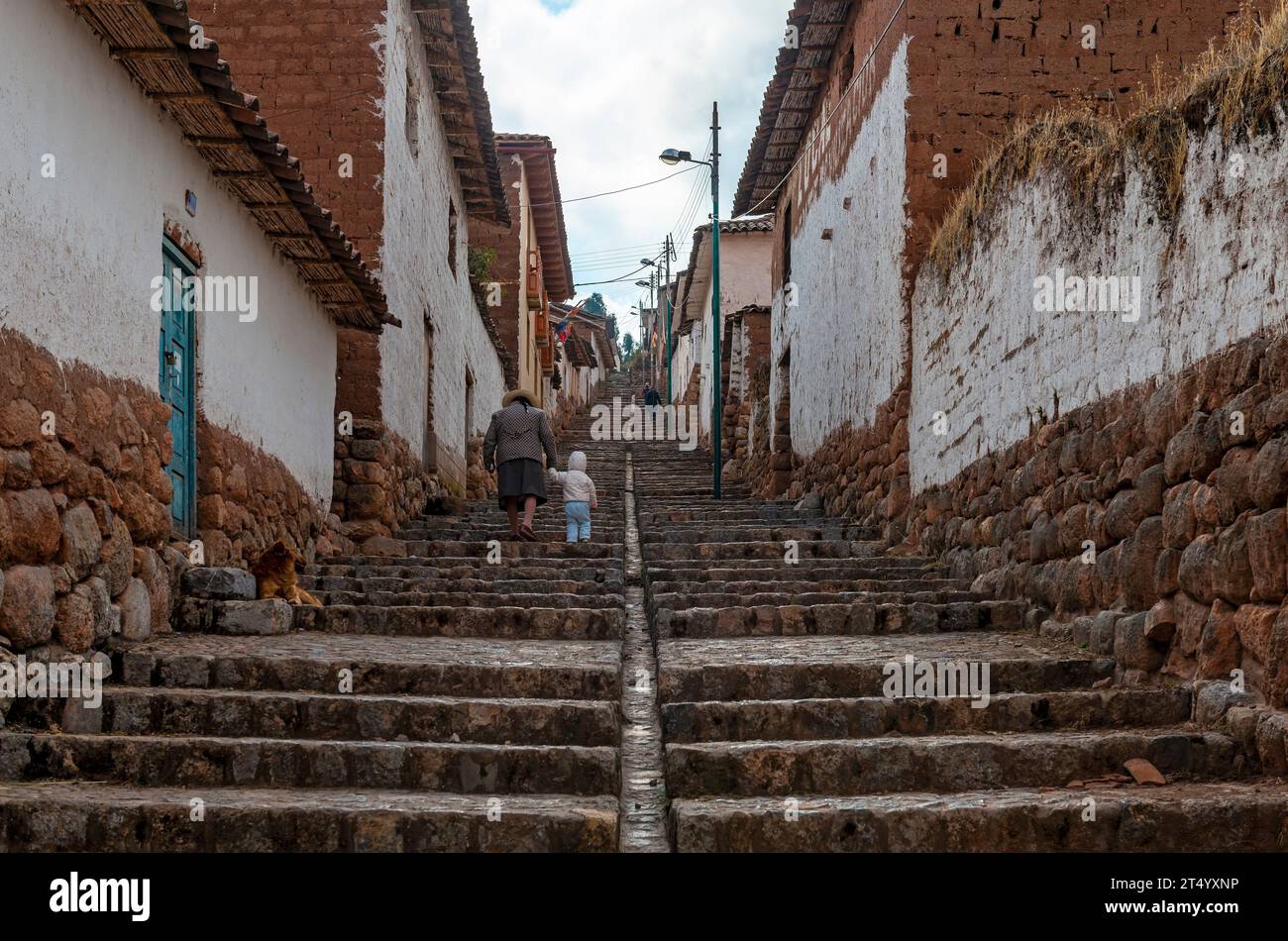 Unrecognizable Quechua indigenous people walking up the steps in ...
