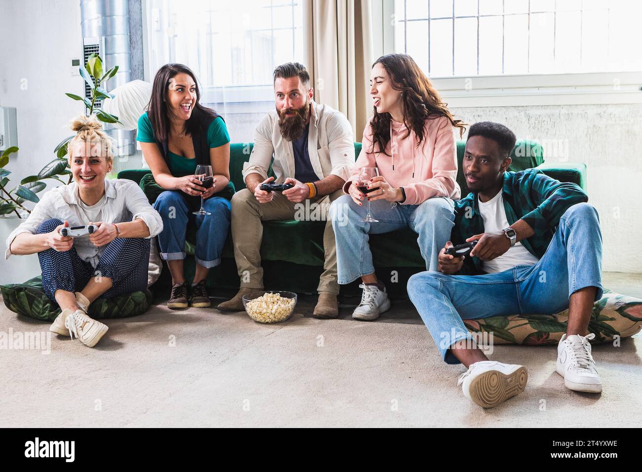 Group of friends having fun and laughing while playing video games. Top ...