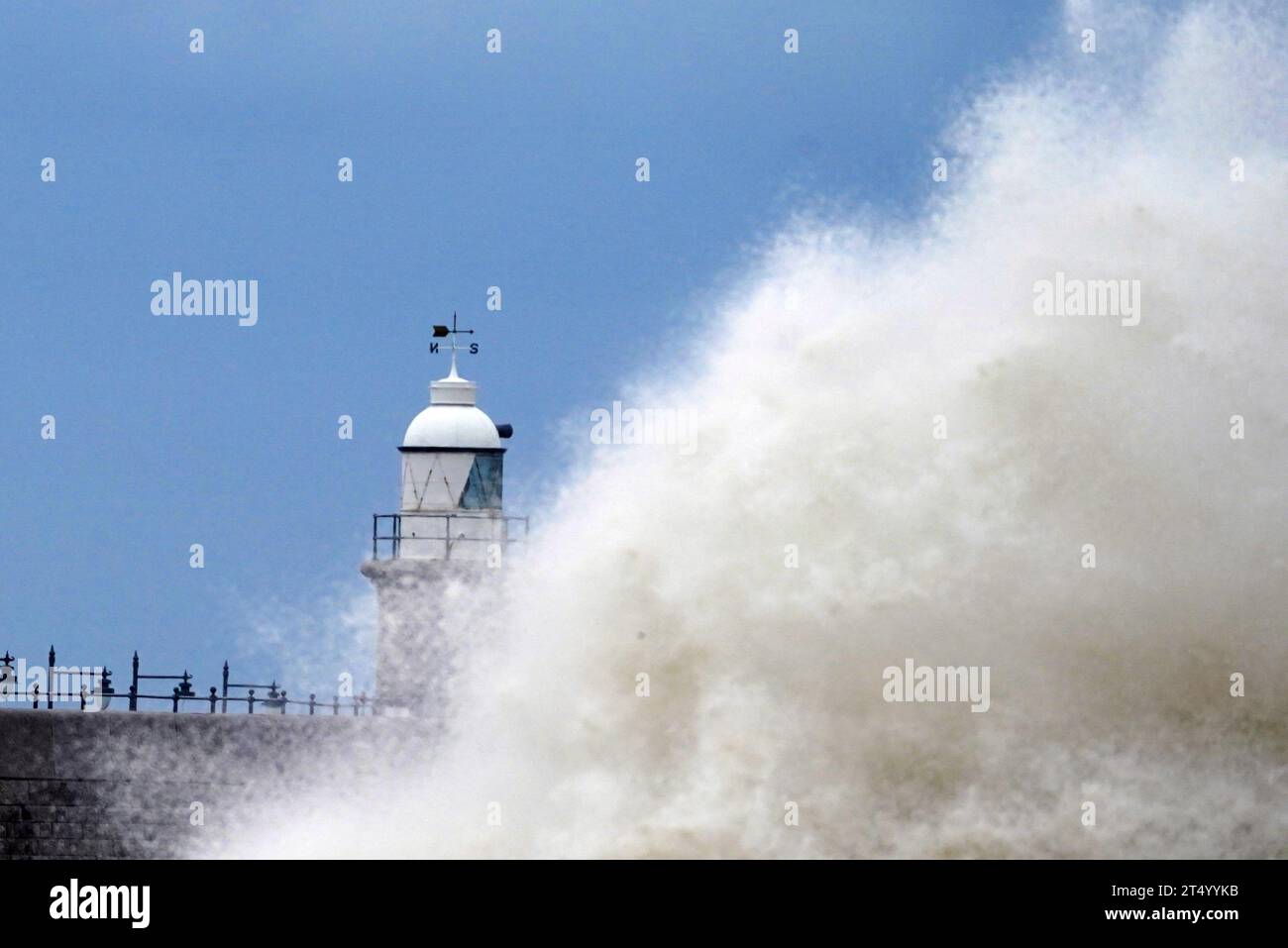 Waves crash around the lighthouse on the harbour arm in Folkestone ...