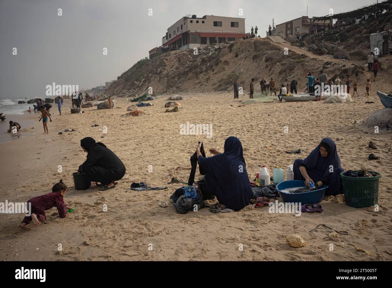 Palestinian women wash clothes with seawater at the beach in Deir al ...