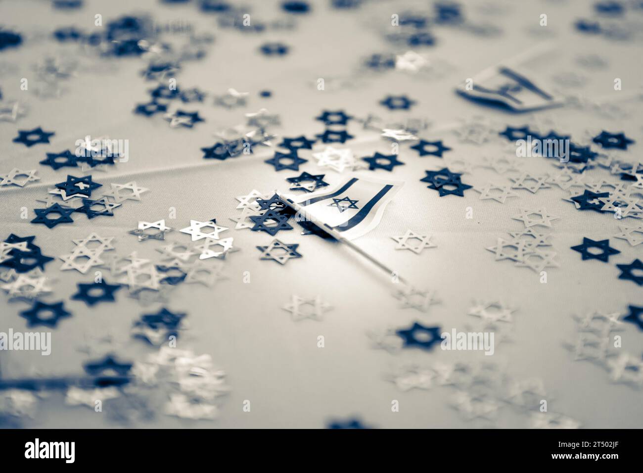 An Israeli flag toothpick and blue and white Jewish stars lie on a ...