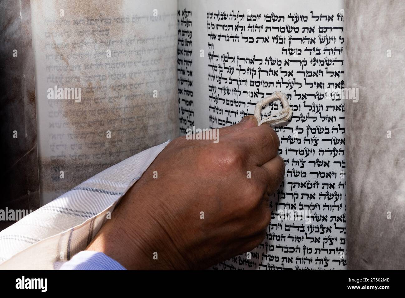 A reader uses a pointer to guide his eyes across the text of a ...