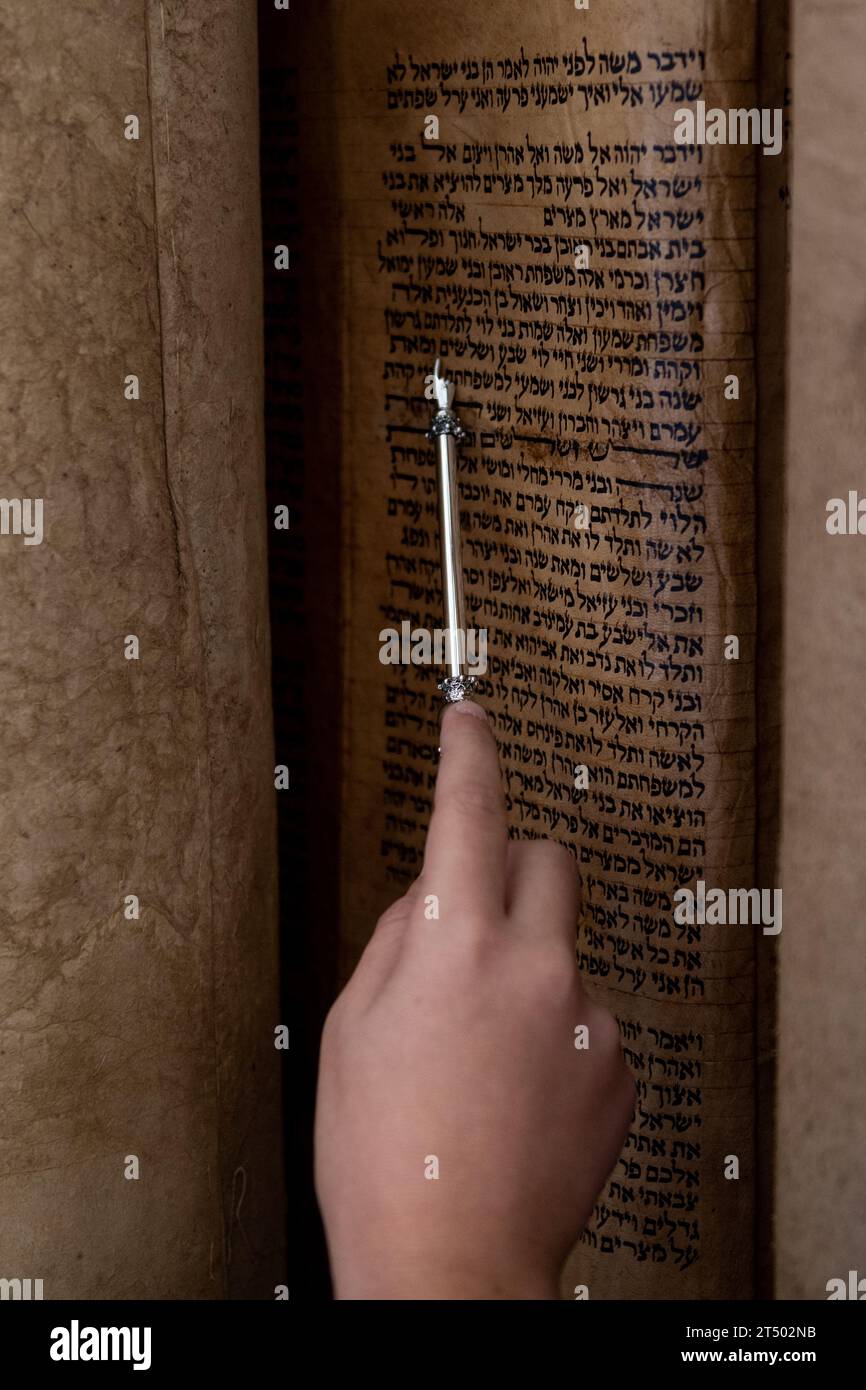 A reader uses a pointer to guide his eyes across the text of a ...