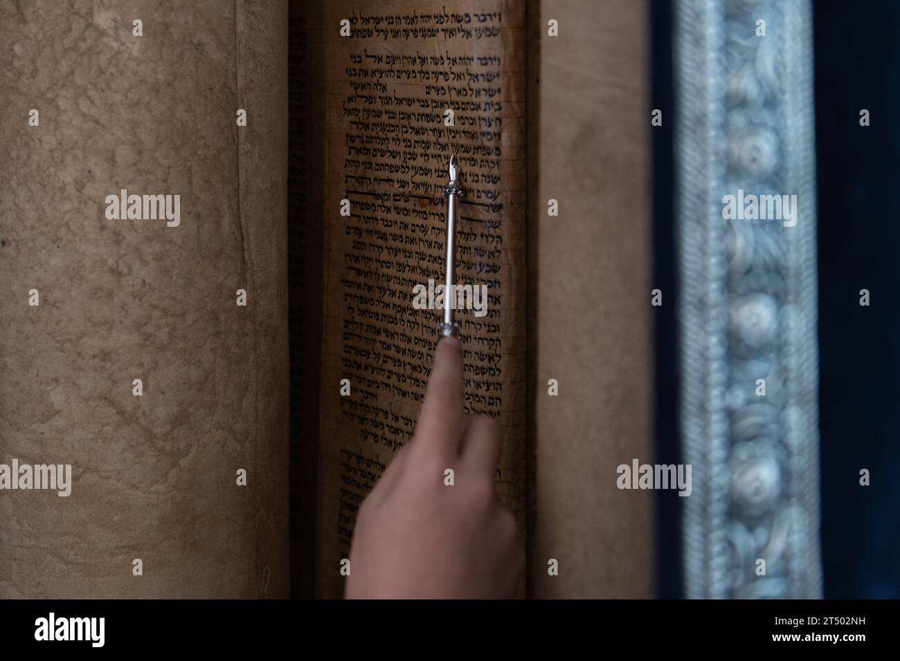A reader uses a pointer to guide his eyes across the text of a ...