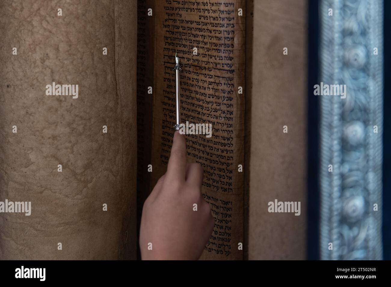 A reader uses a pointer to guide his eyes across the text of a ...