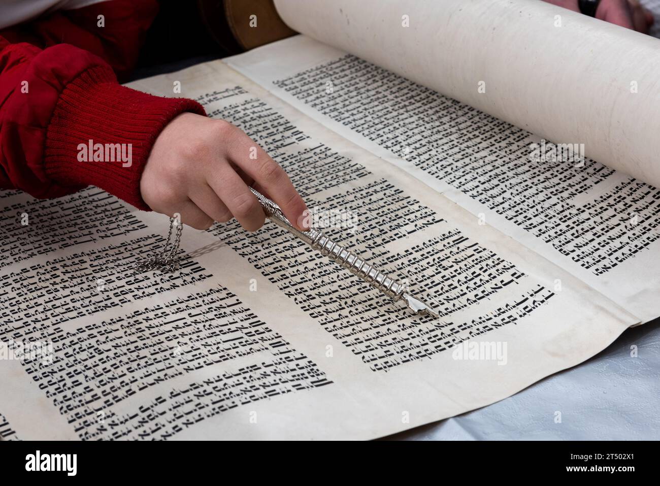 A reader uses a pointer to guide her hand and eyes across the text of a ...