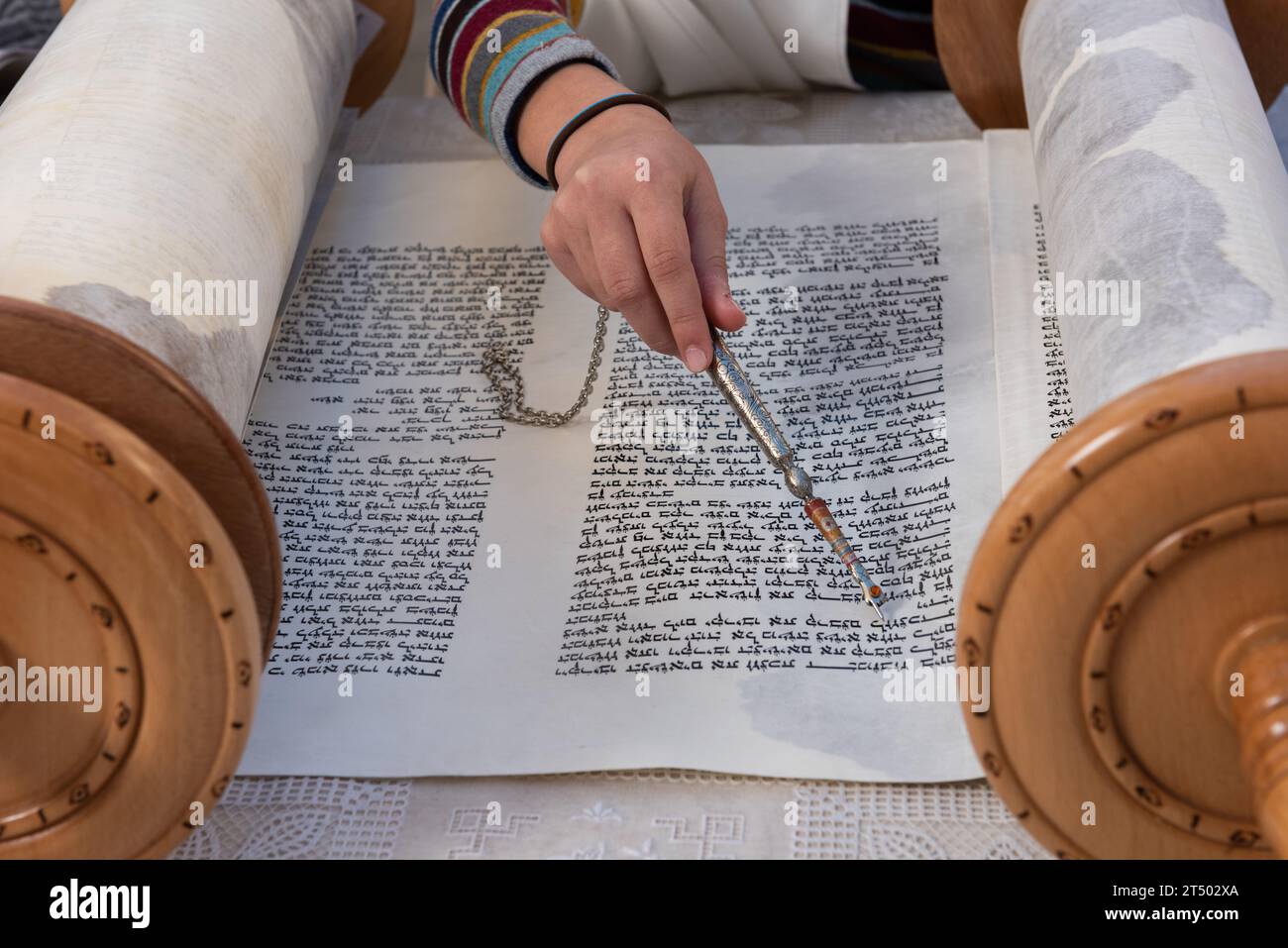 A reader uses a pointer to guide her hand and eyes across the text of a ...