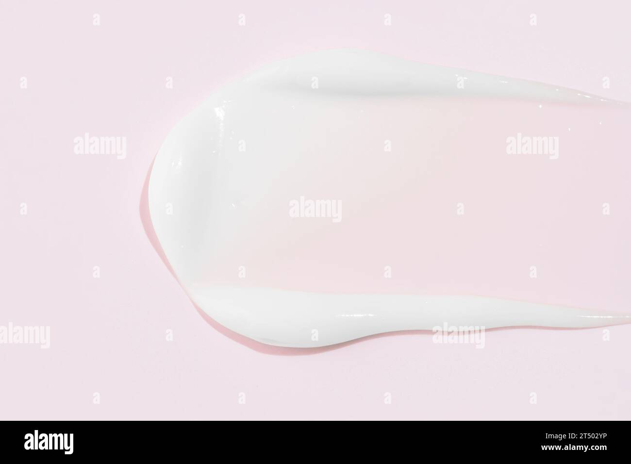 White cosmetic cream texture. lotion swatch on pink background. Beauty ...