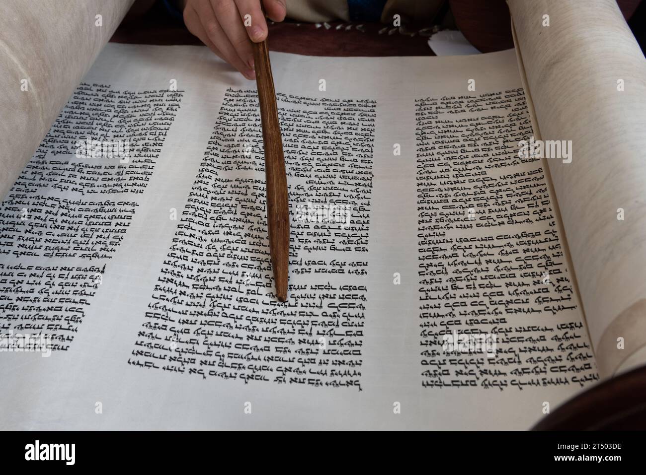 A reader uses a pointer to guide his hand and eyes across the text of a ...