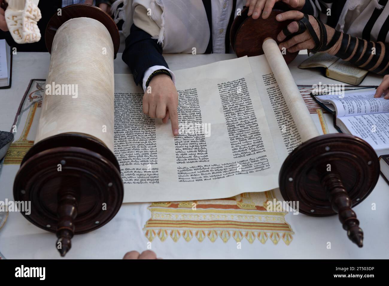 A reader uses a pointer to guide his hand and eyes across the text of a ...