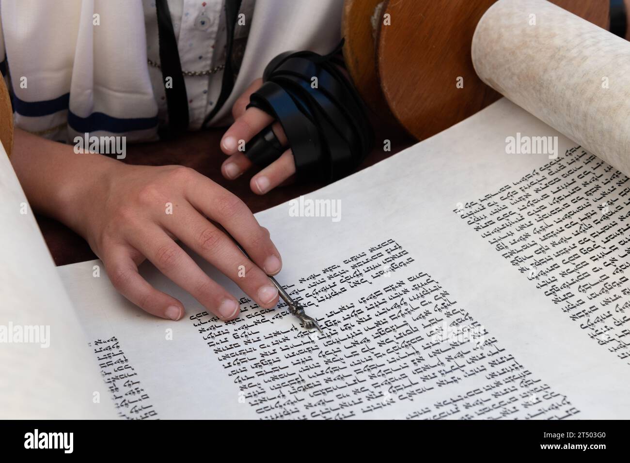 A reader uses a pointer to guide his hand and eyes across the text of a ...