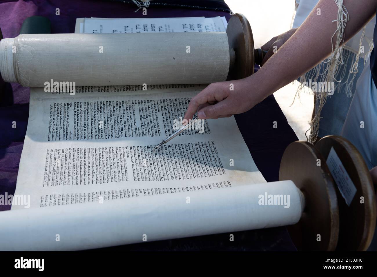A reader uses a pointer to guide his hand and eyes across the text of a ...