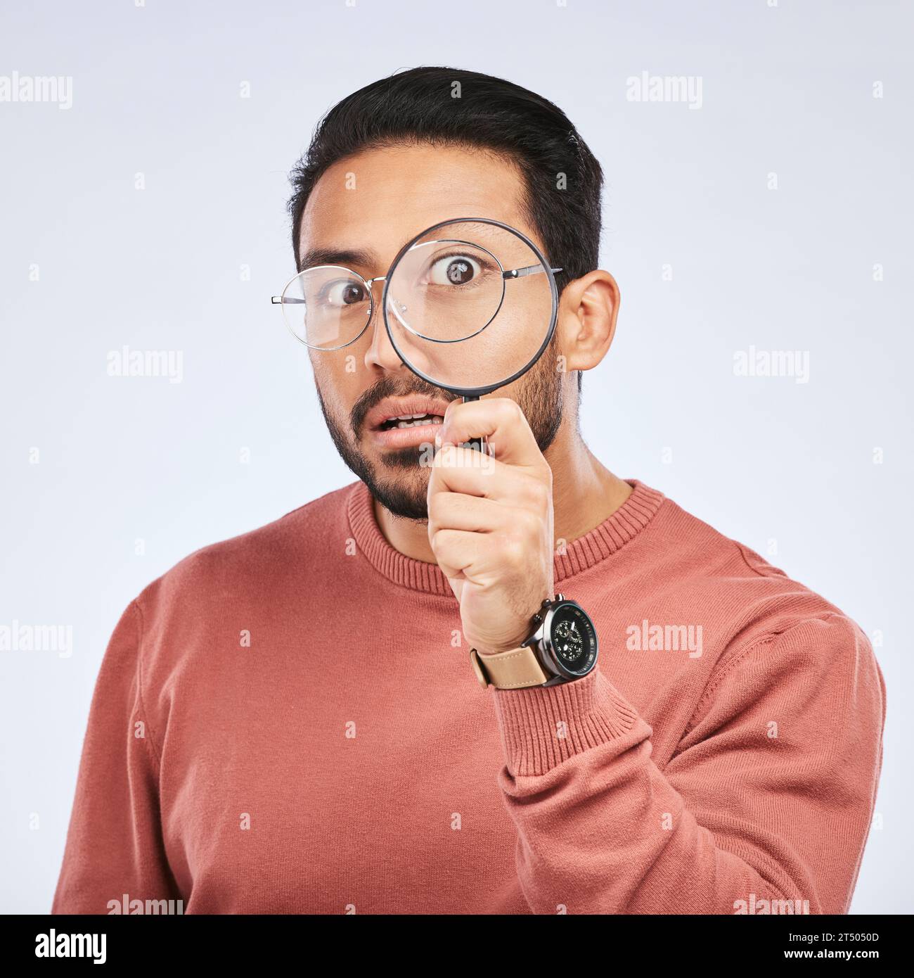 Magnifying glass, man and focus in a studio with investigation for ...