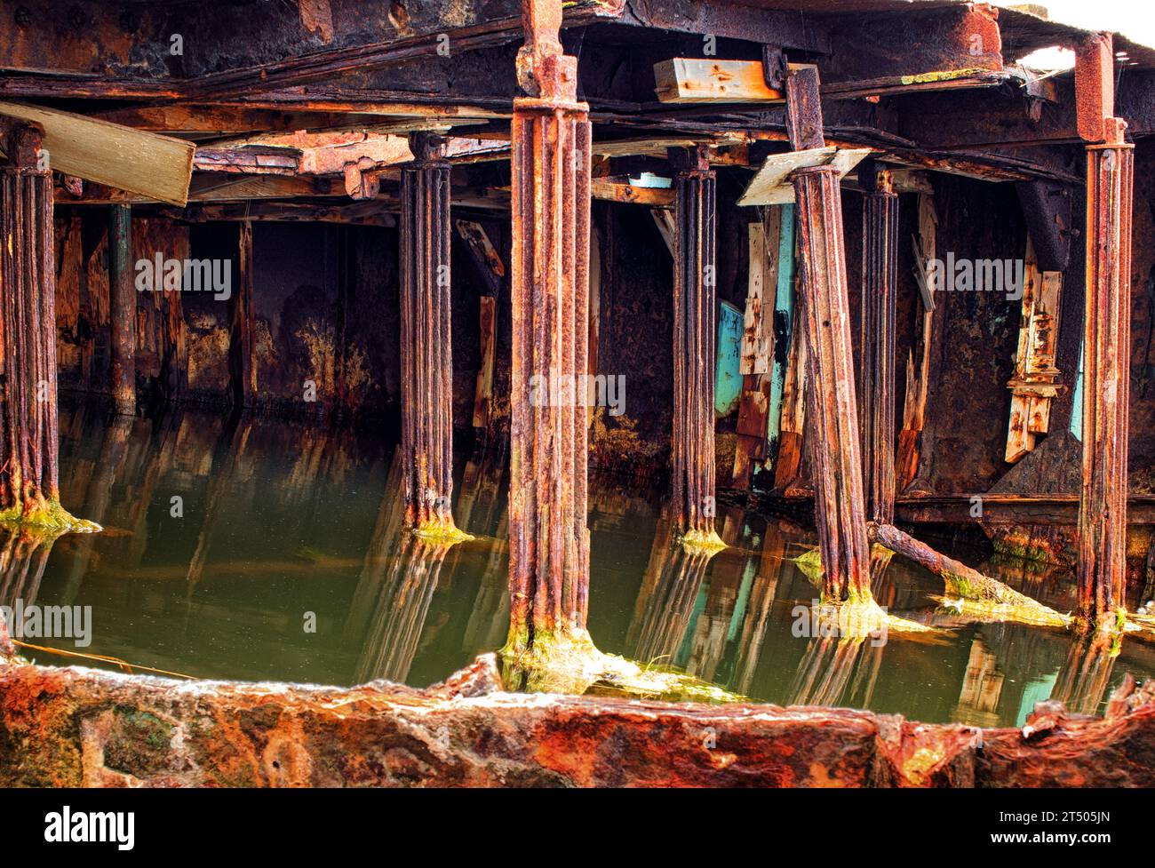 The flooded interior of a wrecked iron boat on the River Wyre, at ...