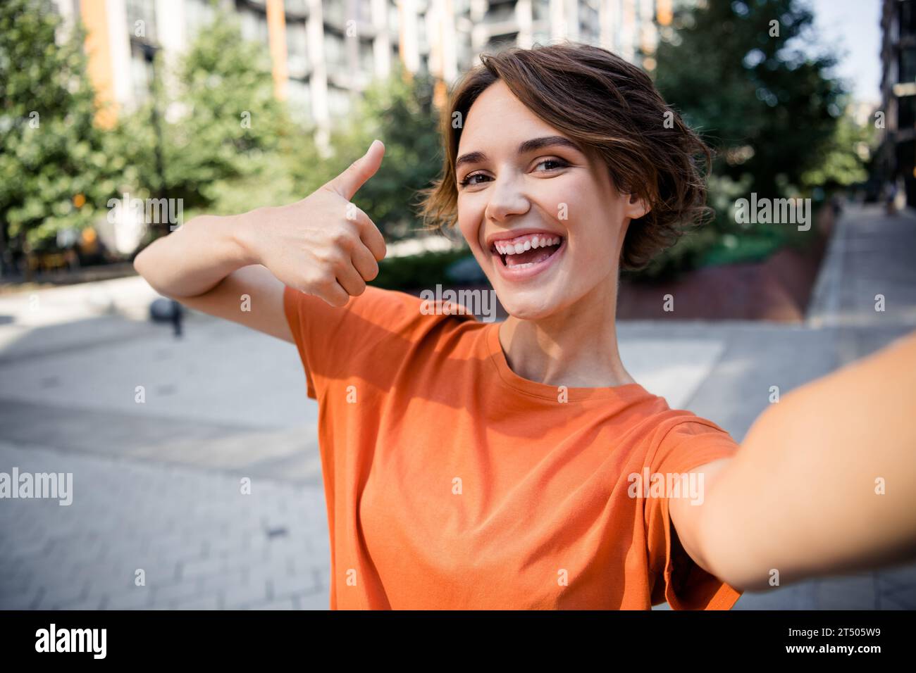 Photo of cheerful positive girl dressed trendy clothes recording vide ...