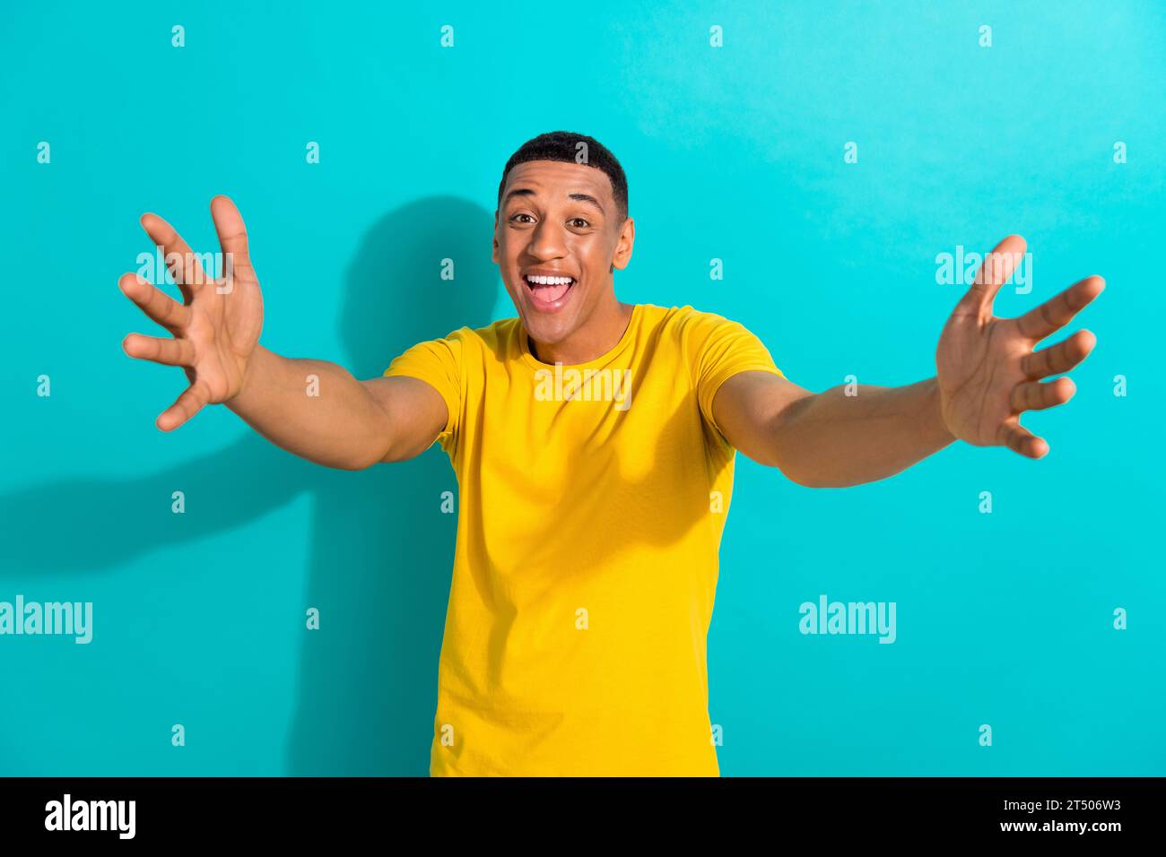 Photo of young man opening his arms excited greetings hello welcome ...
