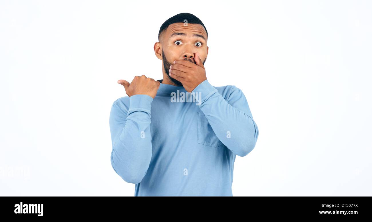 Shock, pointing and portrait of man in a studio with wow, omg or wtf ...