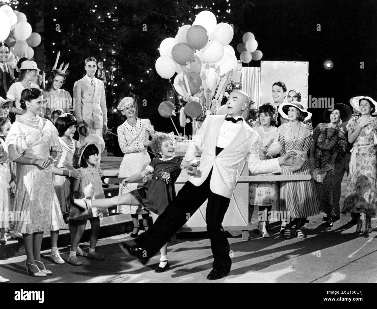 Ann Reinking (left), Aileen Quinn, Albert Finney, on-set of the musical ...