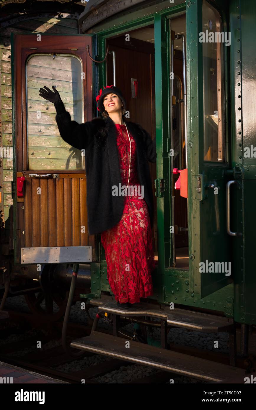 Vintage woman boarding train hi-res stock photography and images - Alamy