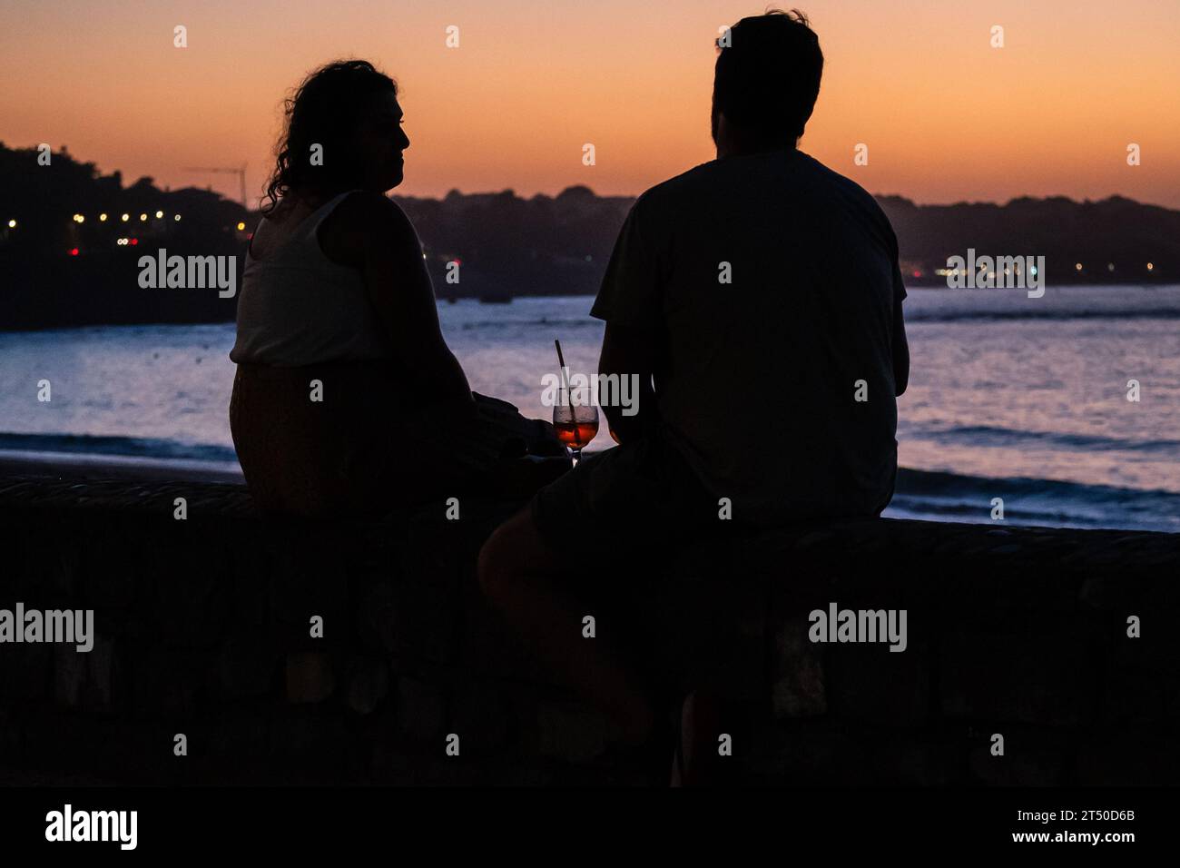 Couple enjoying a drink at sunset, Promenade Jacques Thibaud boardwalk ...