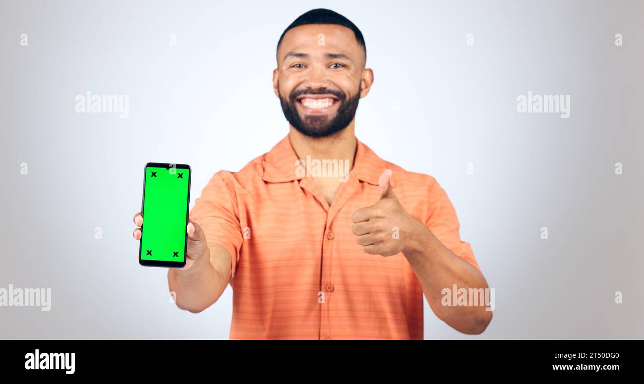 Portrait, man and thumbs up for phone with green screen, space and ...