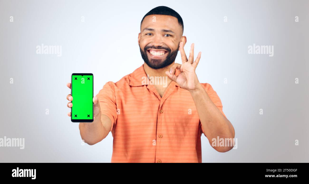 Man, portrait and ok for phone with green screen, space or agreement in ...