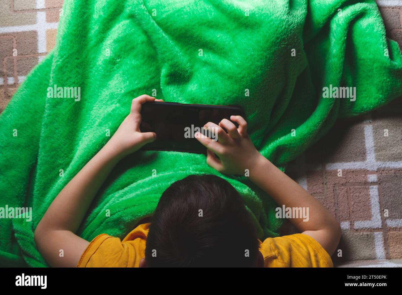 Phone in hands of child. Little boy playing mobile games on smartphone ...
