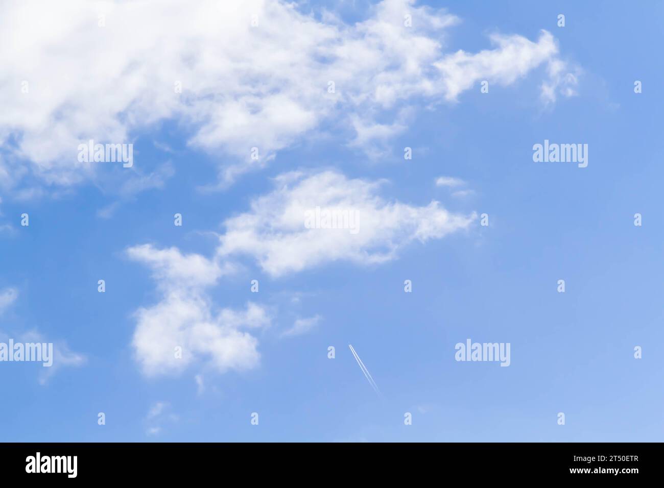 White airy beautiful clouds in a bright blue sky. Clear sunny weather ...